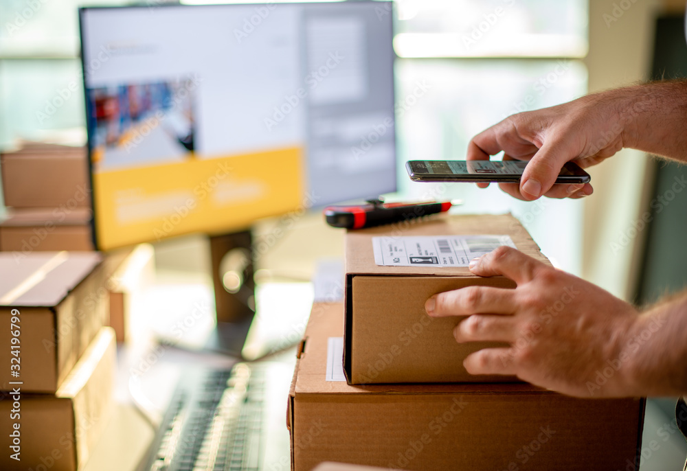 Delivery service, scanning a shipping label Stock Photo | Adobe Stock