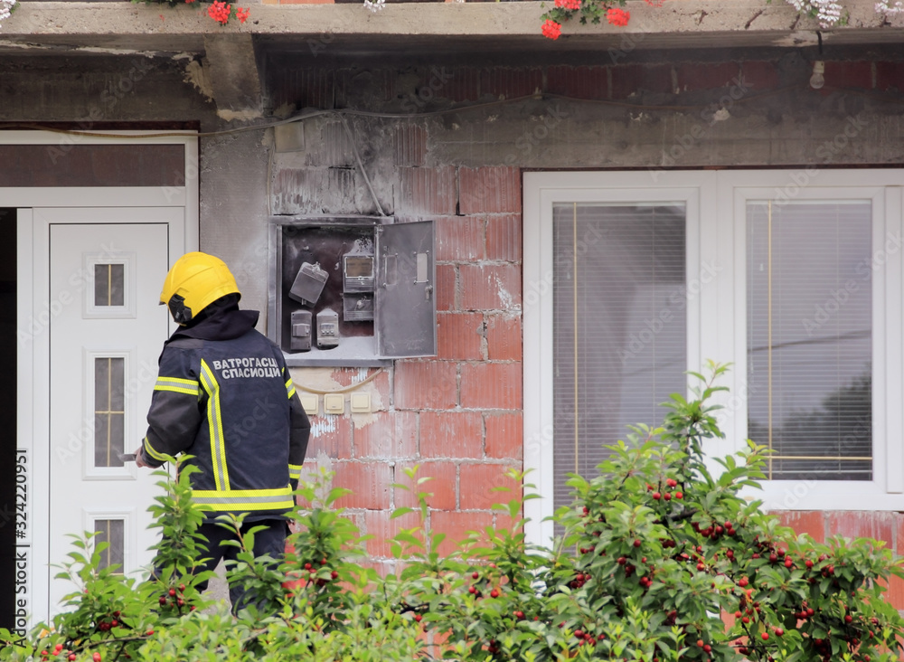 The firefighter monitors the situation after the fire in the electric ...
