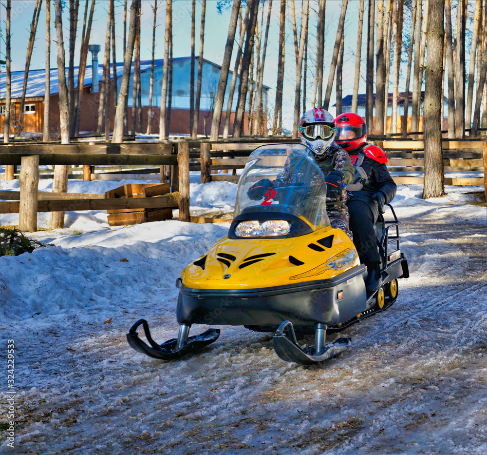 ride a yellow snowmobile Stock Photo | Adobe Stock