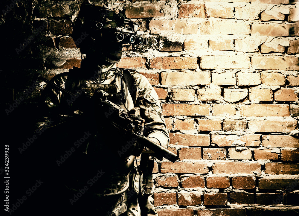 Army special forces tactical group fighter in cqb mission, using radio ...