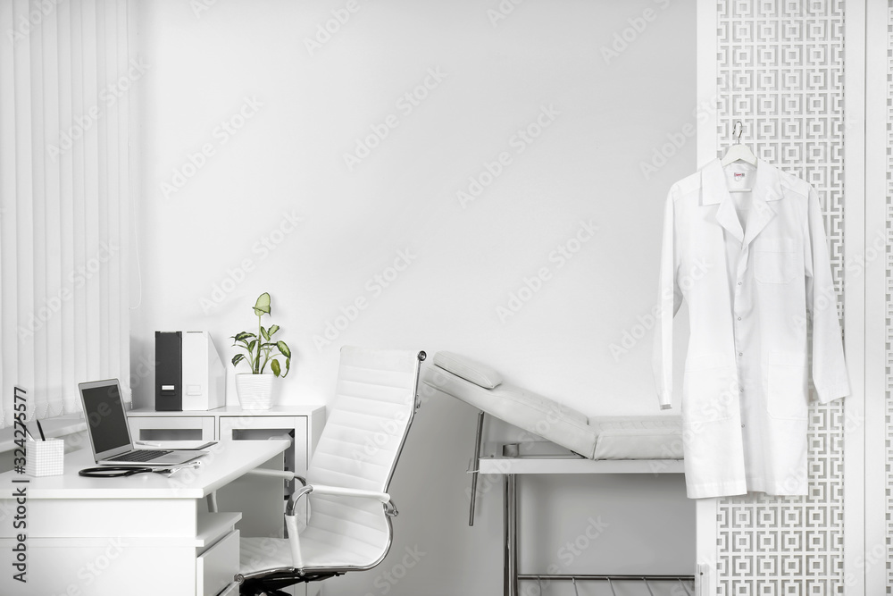 Doctor's office interior with desk and examination couch Stock Photo ...