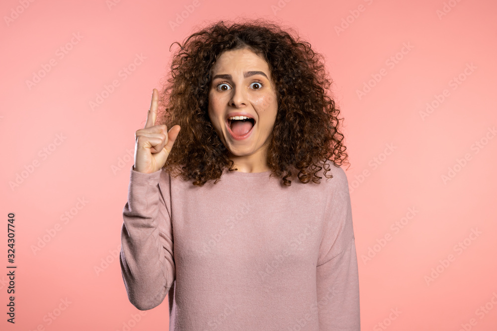 Portrait of young thinking pondering woman having idea moment pointing ...