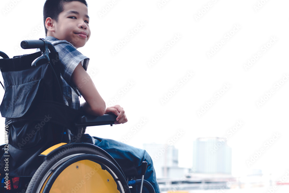 Disabled child on wheelchair feel the freshness on a tall building ...