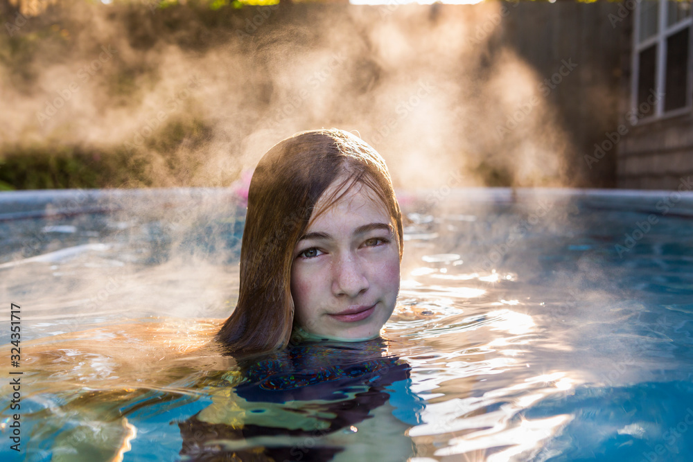 13 year old girl swimming in a pool Stock Photo | Adobe Stock