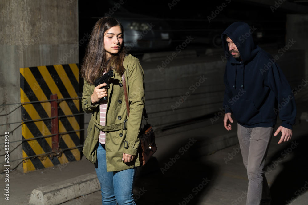 Female Victim Protecting Herself With Gun From Burglar Stock Photo ...