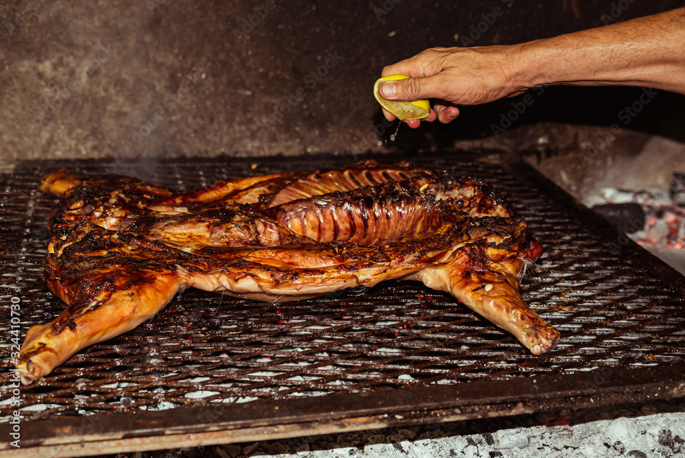 Traditional suckling pig cooked on the charcoal grill. The little pig ...