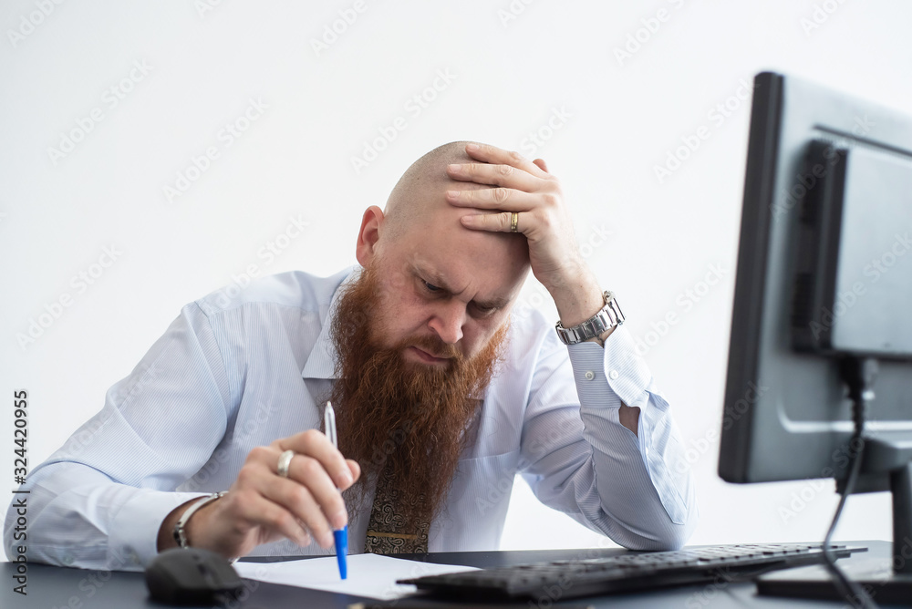 Problems for the office worker. A bald man in a white shirt sits at a ...
