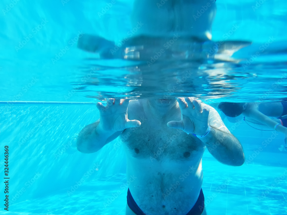 Bodies of boy swimming in a pool under water. Blue Stock Photo | Adobe ...