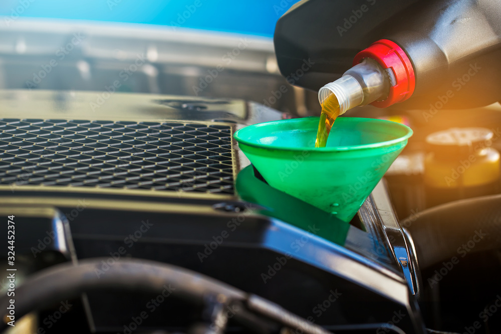 Refueling and pouring oil quality into the engine motor car. Stock ...