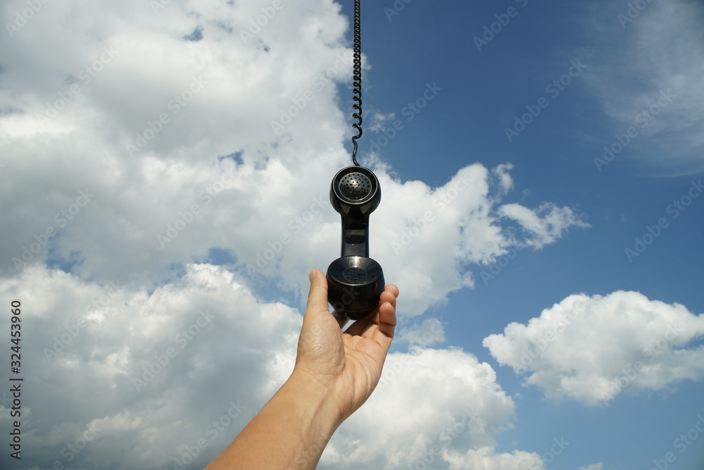 vintage black phone with line hanging from the sky. Conceptual ...