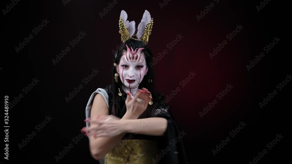 scary fantastic Chinese woman with blood from the mouth and white face ...