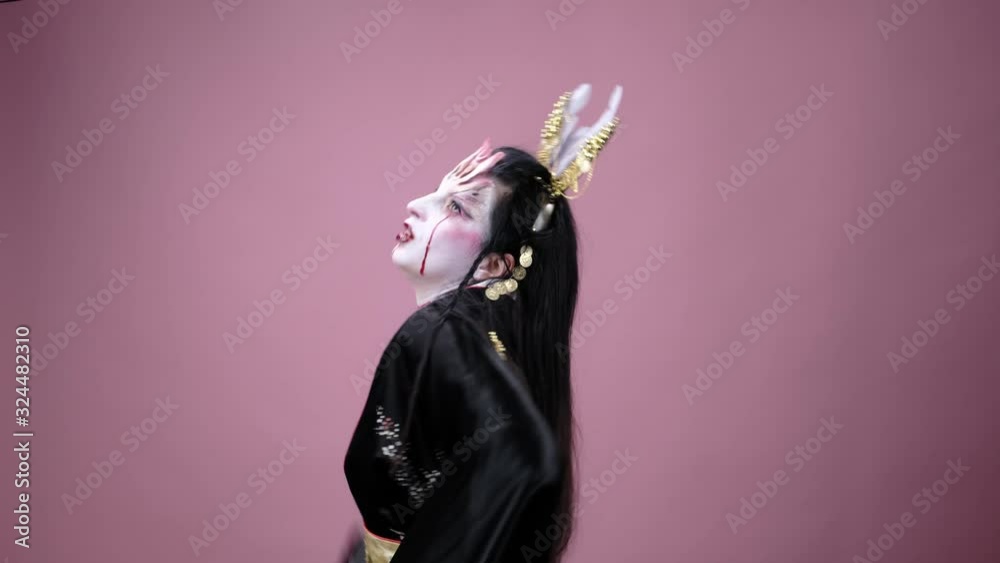 scary fantastic Chinese woman with blood from the mouth and white face ...