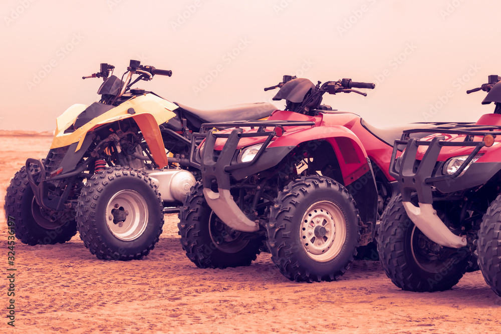 Side view of modern multi-colored all-terrain vehicles stand in the ...