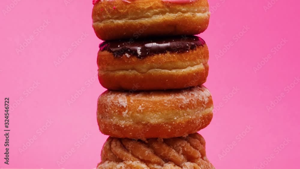 Donuts pile in the middle of the frame spinning around. Stop motion ...