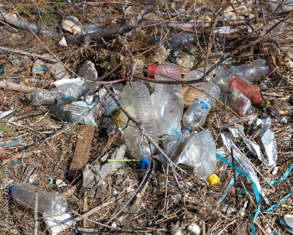 Dirty Garbage . Spilled garbage on the beach near the big city. Empty ...