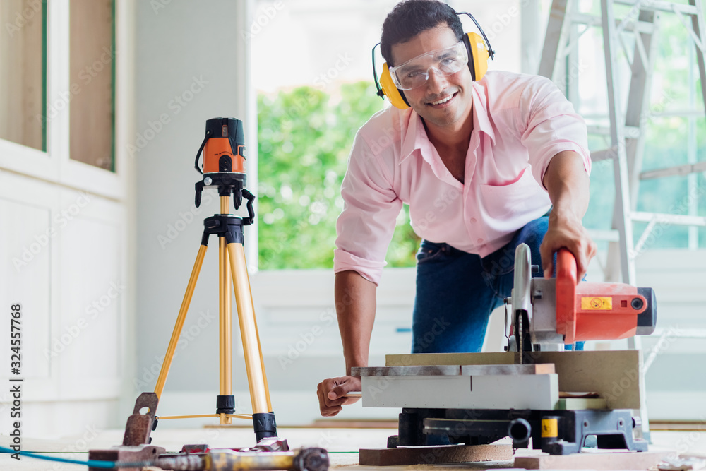 Smart indian contractor hand using sawing machine wood work and working ...