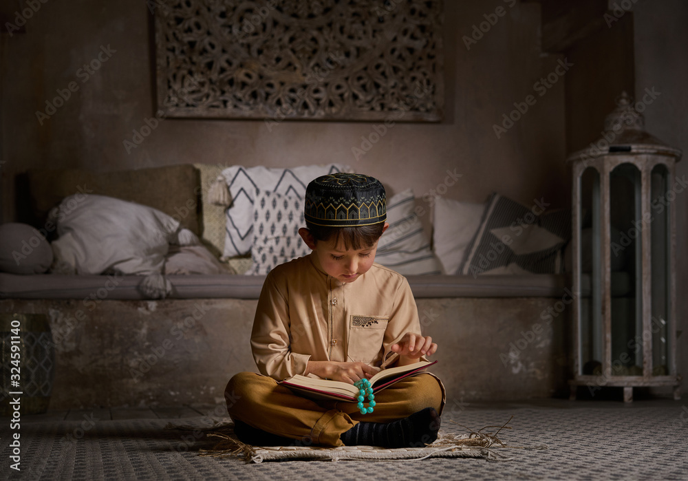 Little muslim boy in prayer cap and arabic clothes with rosary beads ...