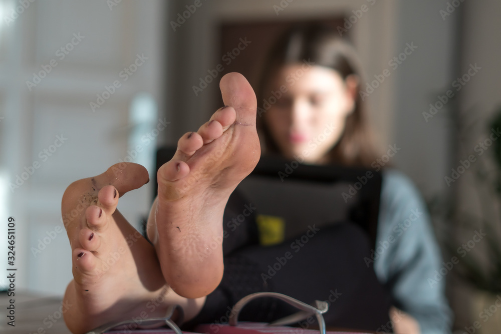 Woman using computer with her feet on the desk Stock Photo | Adobe Stock