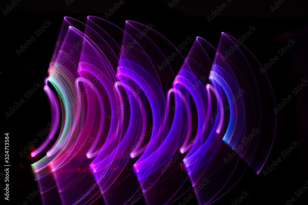 Curved abstract shape made with a light saber violet. Lightpainting ...