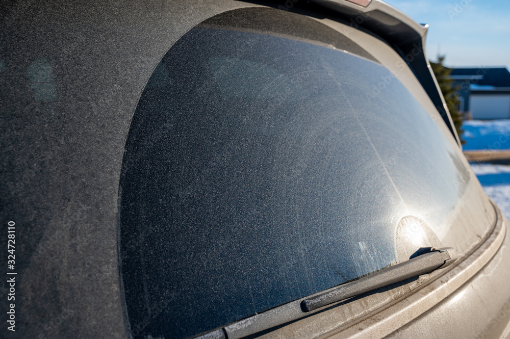 Grit and dust covered rear window of a van with wiper track Stock Photo ...