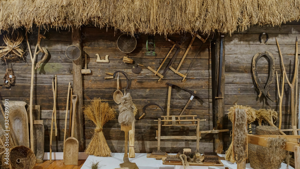 Close-up view with old attributes of rural life. Yarn, sickle, seive ...