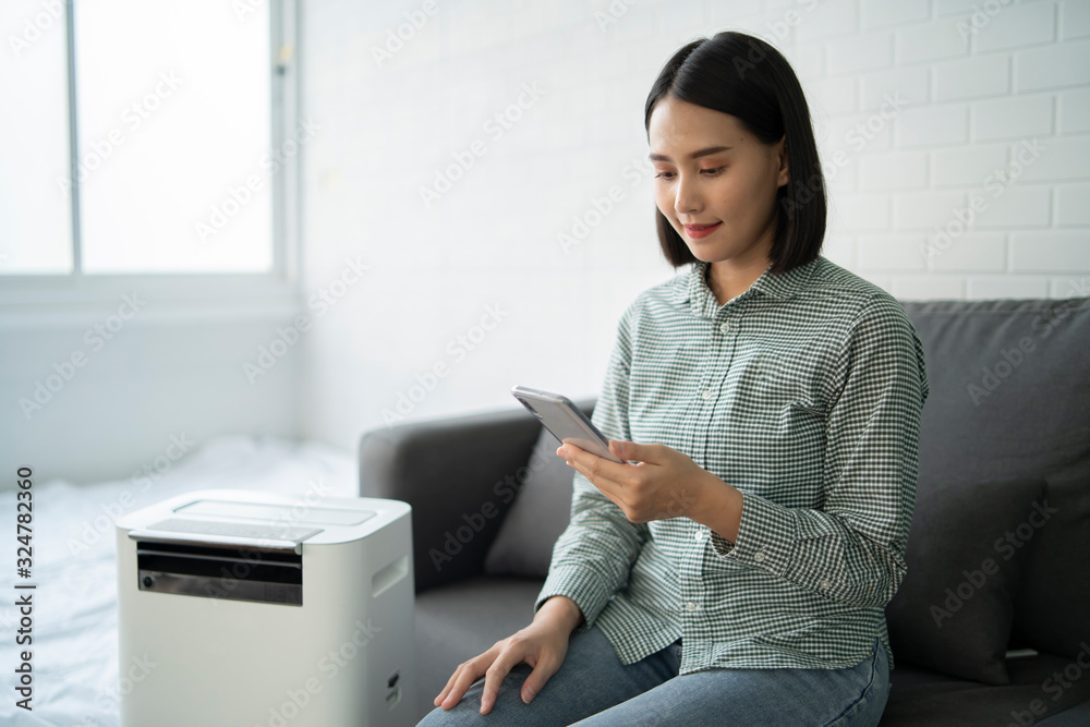 Air purifier , Asian Business woman working with laptop use phone with ...