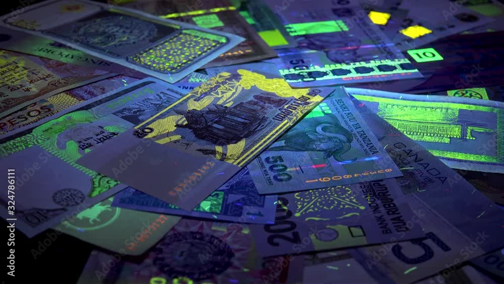 Banknotes of different countries in the UV light (fluorescence of ...