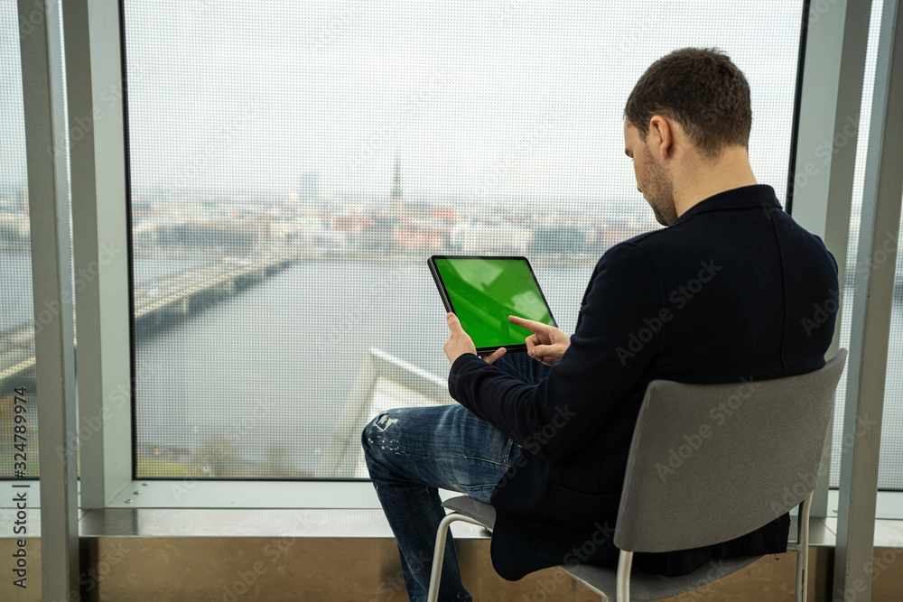 Man sitting on chair, watching and typing on professional Digital ...