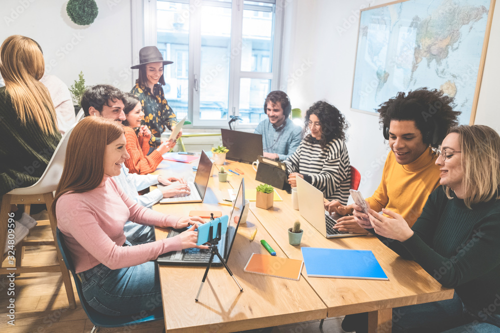 Young co-workers team talking during startup - Happy people planning a ...