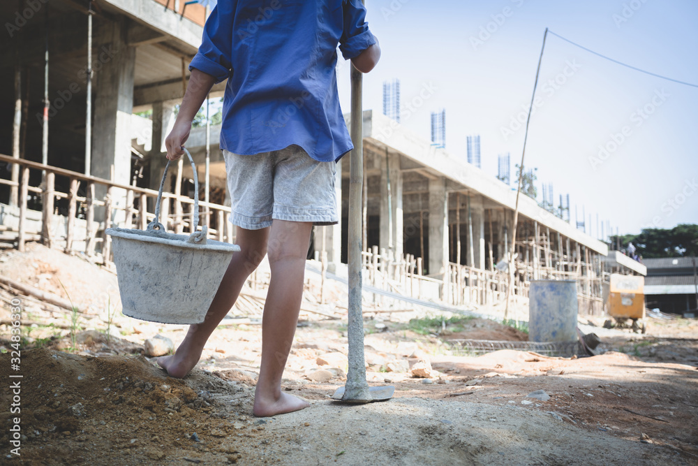 boys labor work in the construction site, Against child labor, Poor ...
