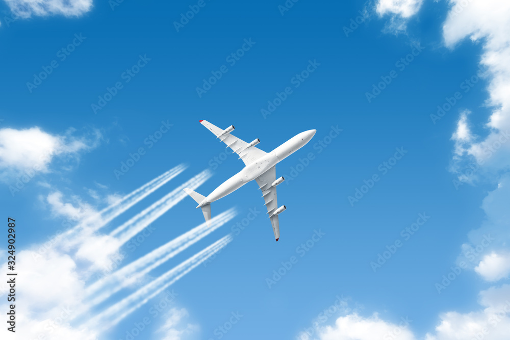 modern airplane flying high above clouds landscape against blue sky ...