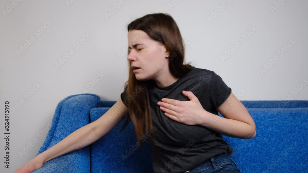 Upset stressed young woman feeling pain ache touching chest having ...
