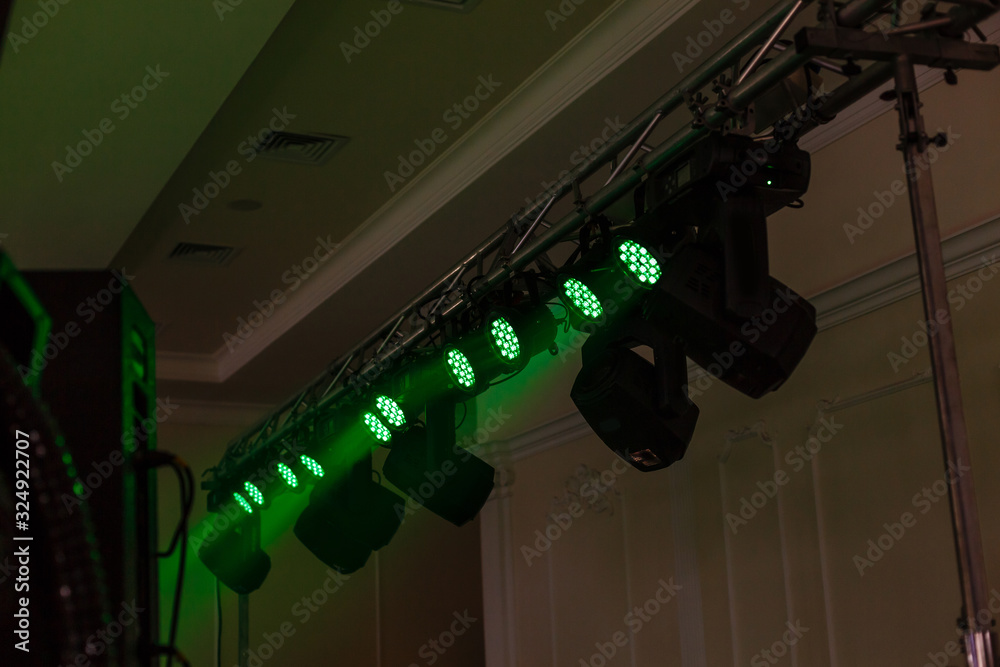 Green stage lights. Concert spot lighting. Stage lights console. Rays ...