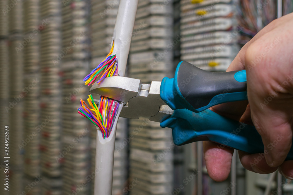 Network internet cable is torn with a sharp tool. The concept of vandal ...