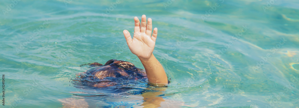 kid is drowning in the sea. Selective focus. Stock Photo | Adobe Stock