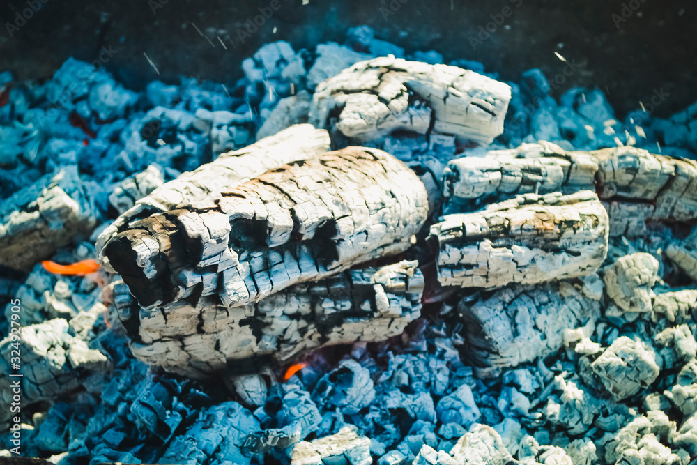 Smoldering ashes of a bonfire. Incandescent orange and red embers ...