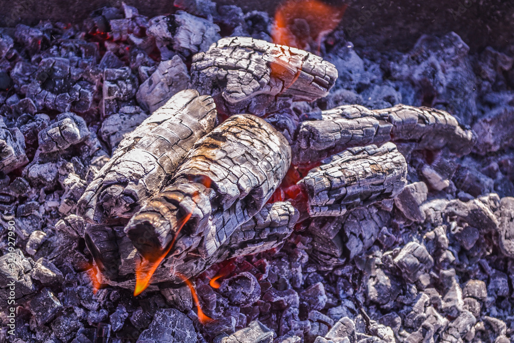 Smoldering ashes of a bonfire. Incandescent orange and red embers ...