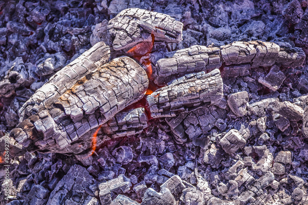 Smoldering ashes of a bonfire. Incandescent orange and red embers ...