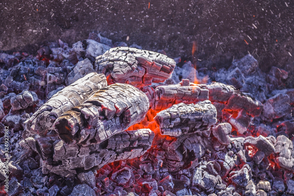 Smoldering ashes of a bonfire. Incandescent orange and red embers ...