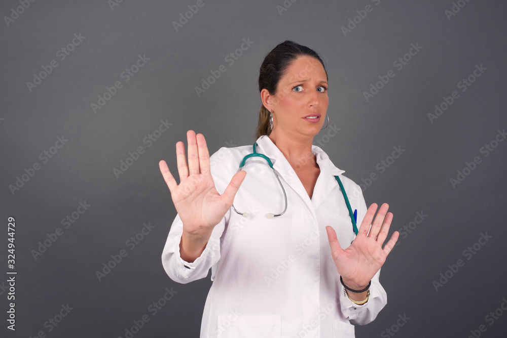 Dissatisfied doctor female model frowns face, has disgusting expression ...