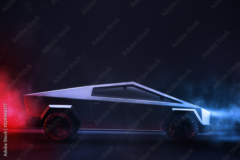 Tesla brand cybertruck pickup car on a dark background with lights ...