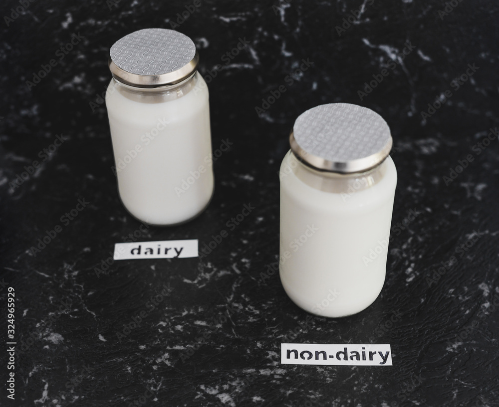 bottles of milk with Dairy and non-dairy labels in front of them Stock ...