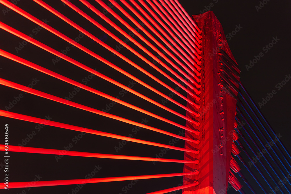 The illuminated structure of the Seri Saujana Bridge at night. One of ...