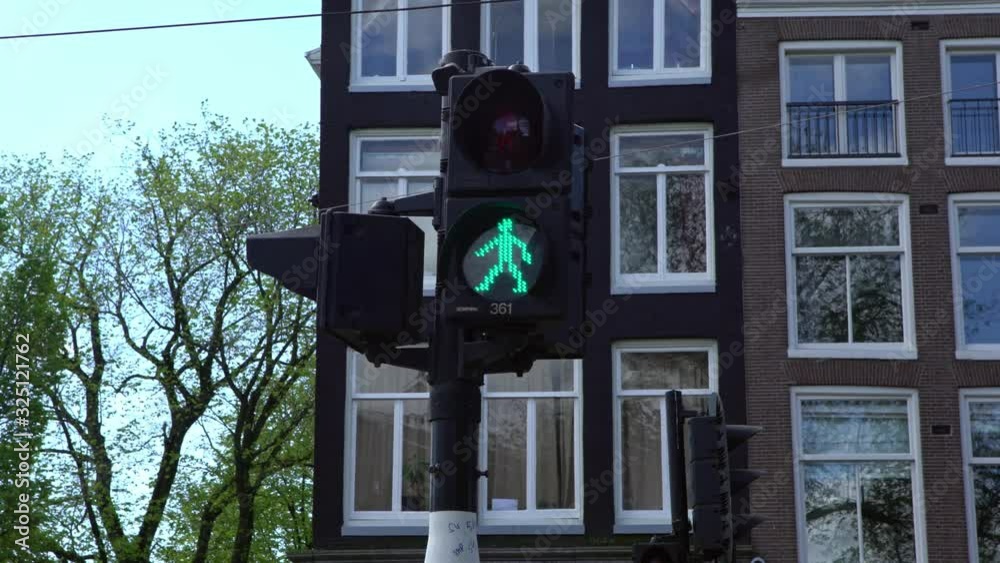 4K, European pedestrian crosswalk sign Amsterdam city traffic with ...