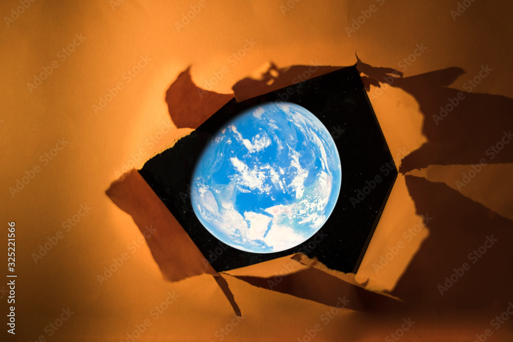 Hole in broken paper with globe, and broken and torn paper with hole in ...