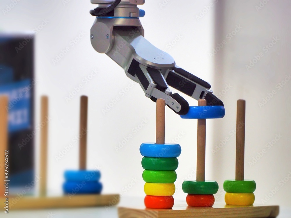 Robotic hand moving an object representing artificial intelligence in ...