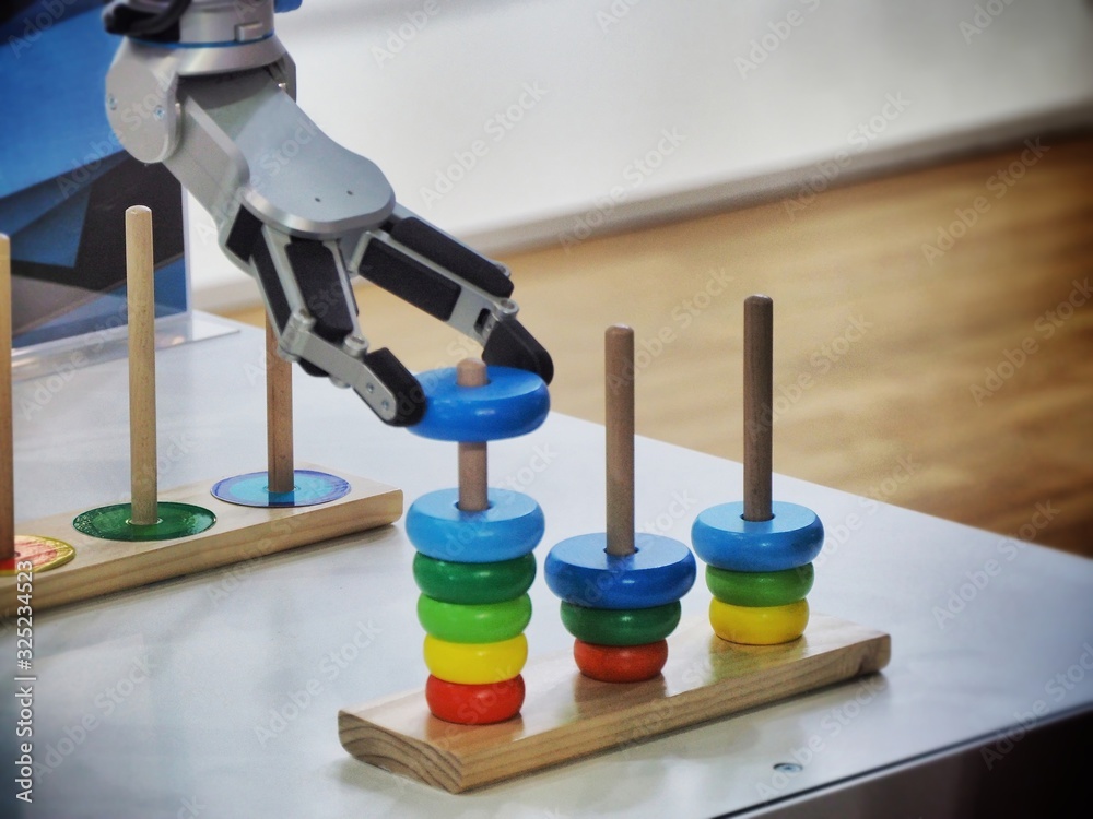 Robotic hand moving an object representing artificial intelligence in ...