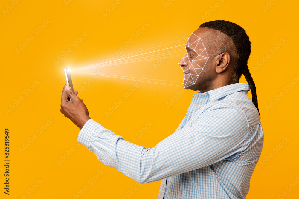 Mature african man scanning his face with mobile app Stock Photo ...