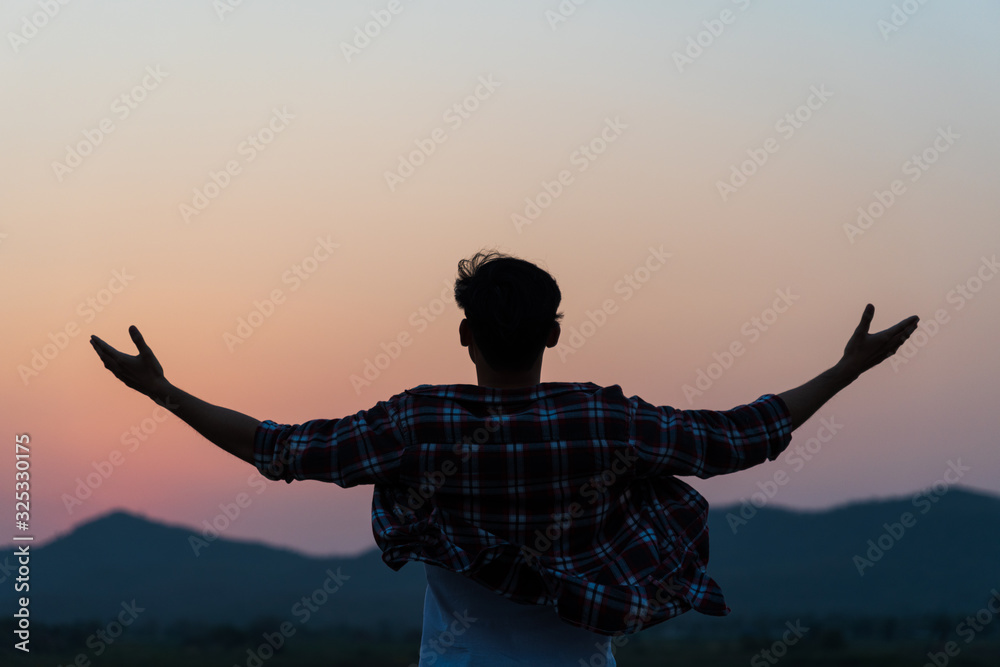 Rear view of happy man spreading arms and watching the mountain. Travel ...