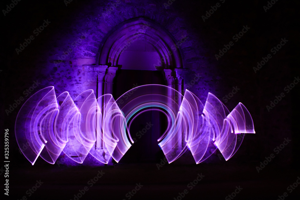 Lightpainting scene. Abstract shapes with a light saber at night ...
